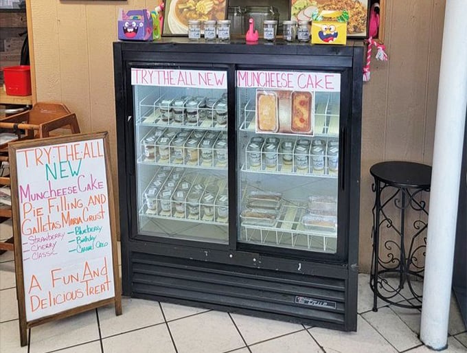 The dessert case beckons with "Muncheese Cake"—proof that sometimes the best culinary innovations come with hand-written signs.
