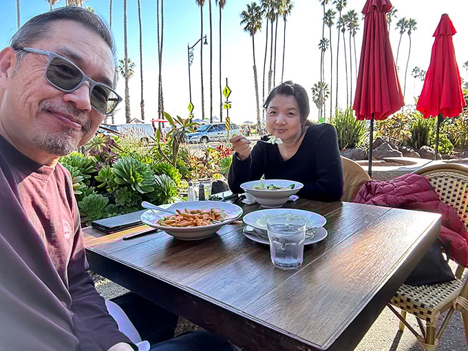 Outdoor dining with palm trees swaying overhead – the quintessential California experience that makes even locals feel like they're on vacation.