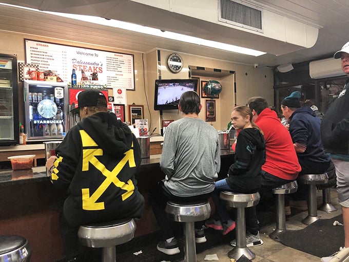 The counter seats are like front-row tickets to the best show in town – watching hungry patrons experience cheesesteak bliss.