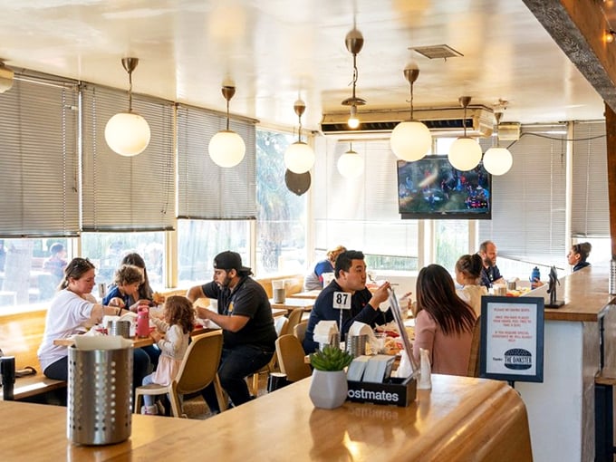 The diverse crowd at The Oinkster proves good food is the ultimate unifier—everyone's speaking the universal language of "mmm" regardless of native tongue.