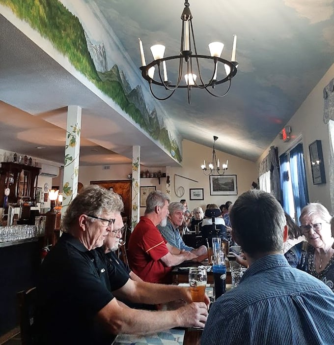 The dining room buzzes with conversation and clinking steins under a ceiling painted to mimic the Bavarian sky—no passport required.