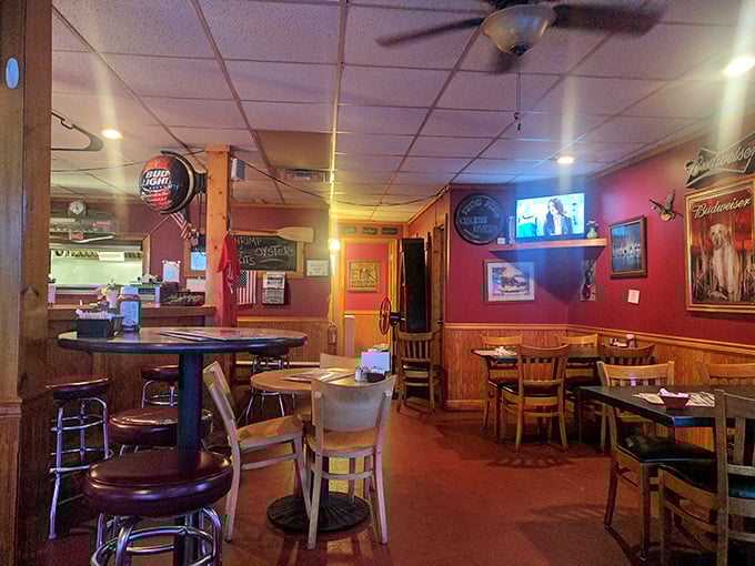 The dining area blends rustic charm with hometown comfort – red walls, wooden accents, and the promise of conversations worth overhearing. 