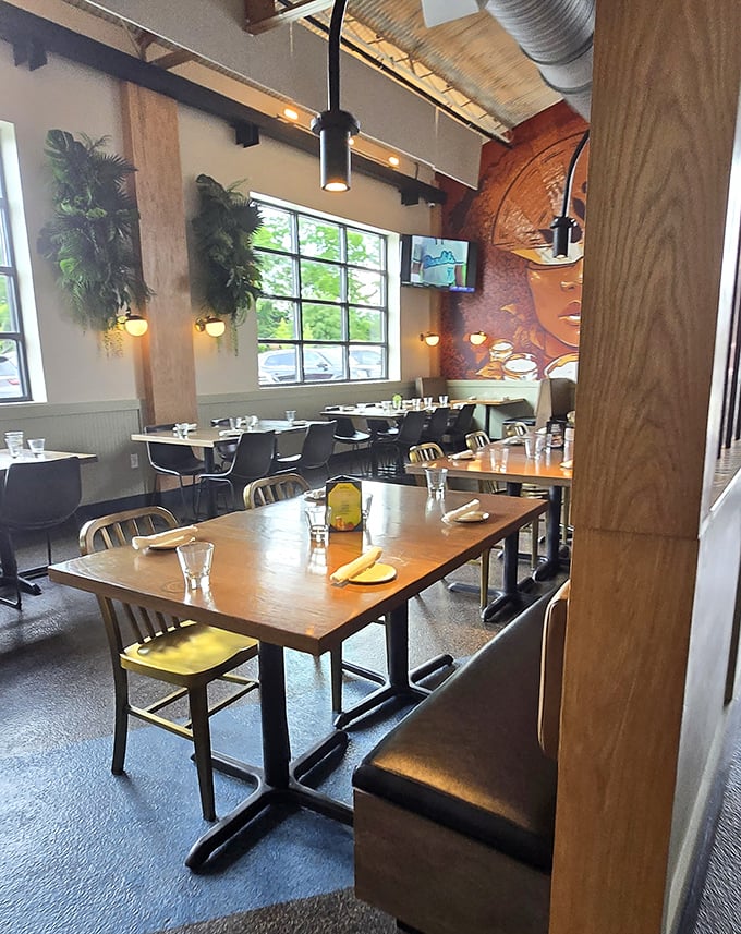 Dining area that whispers "stay awhile" with its hanging plants and natural light. That mural isn't just watching you eat—it's approving.