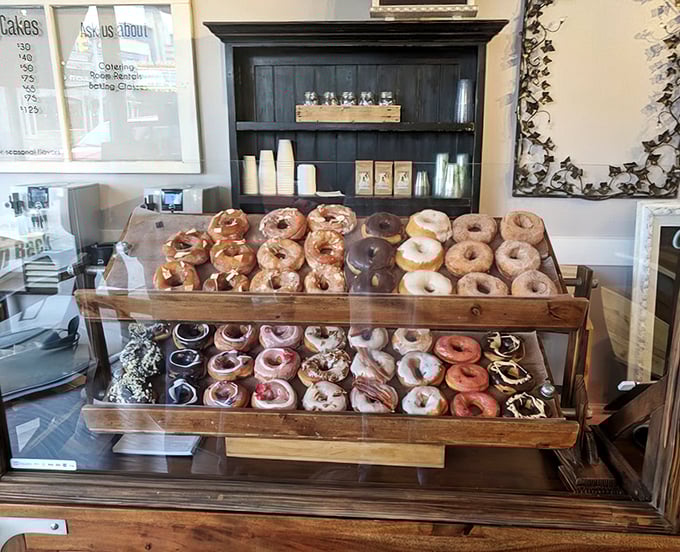 The display case—a museum of deliciousness where each shelf tells a different story of sugar, spice, and everything nice.