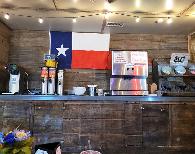 The drink station—where sweet tea flows like liquid gold—stands ready beneath rustic wood walls and the ever-present Texas colors.