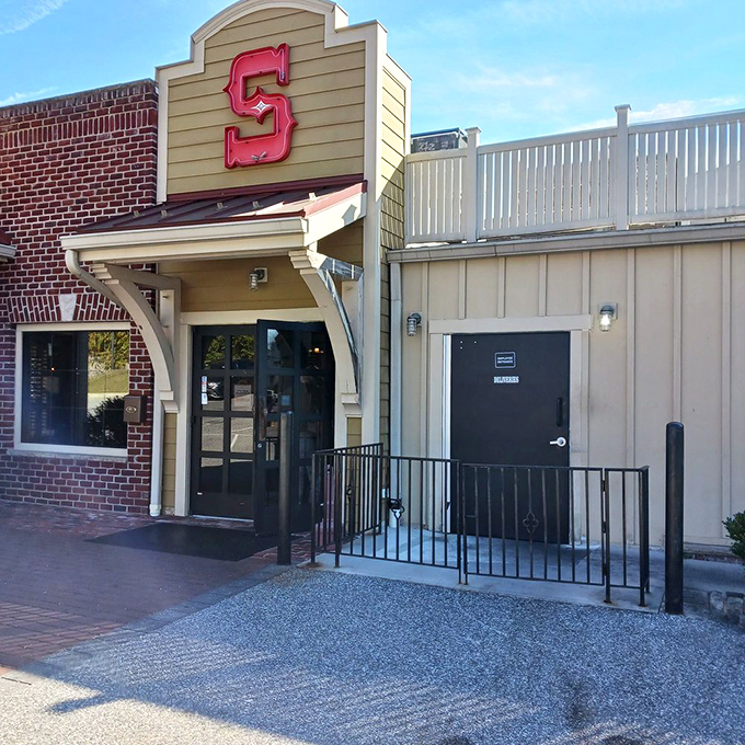 The iconic red "S" sign beckons hungry travelers like a lighthouse guiding ships to safe harbor—except this harbor serves crab cakes.