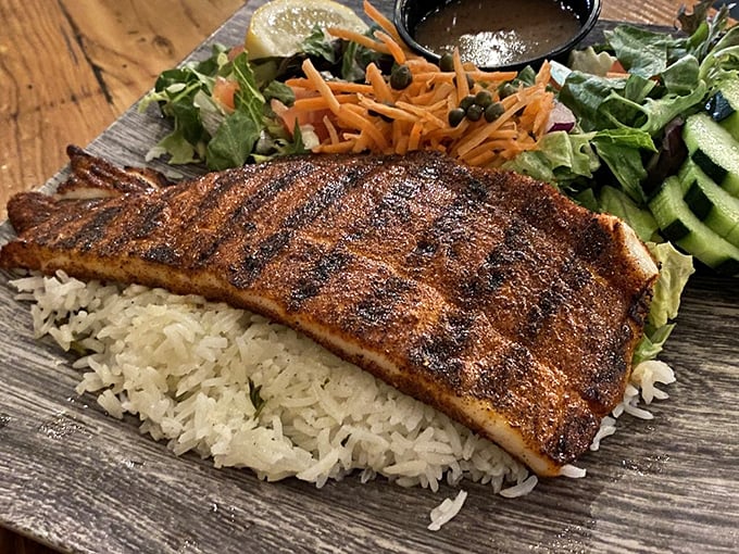This blackened fish doesn't just sit on rice—it reigns over it, with a spice crust that would make New Orleans proud.