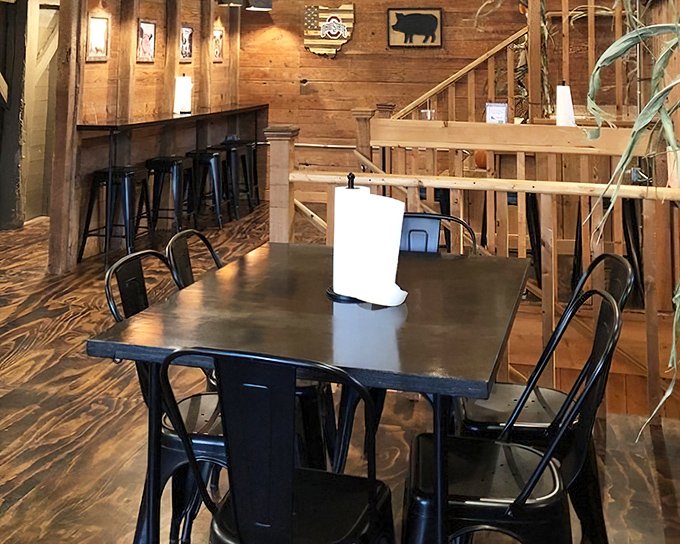 Wood-paneled walls and black metal chairs create the perfect backdrop for the real star—whatever's about to arrive on your plate.