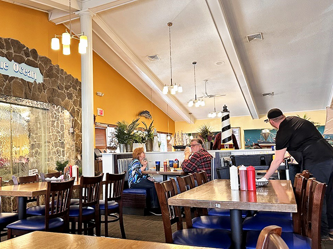 Warm yellow walls and maritime décor create that "come as you are, leave fuller than you planned" atmosphere locals adore.