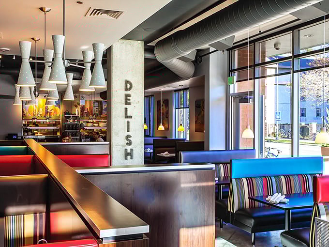 Colorful booths pop against industrial elements—proof that brunch spots, like the best breakfast plates, balance comfort with just enough excitement.