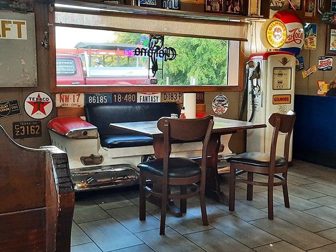 The car-seat-turned-booth isn't just clever recycling—it's the perfect spot to park yourself for a meal surrounded by vintage license plates. 