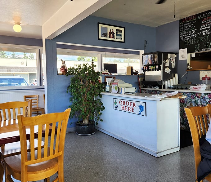 The ordering counter—where seafood dreams begin. That potted plant adds a homey touch to this no-nonsense operation.