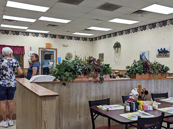Plants and horse-themed decor create that quintessential country restaurant vibe—like dining in the cozy corner of a rural Indiana living room.