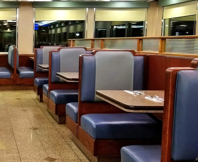 The blue vinyl booths aren't just seating—they're time machines to when conversations happened face-to-face instead of through screens.