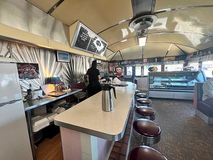 The curved ceiling and row of classic counter stools create the quintessential diner silhouette—a space where conversations flow as freely as the coffee.