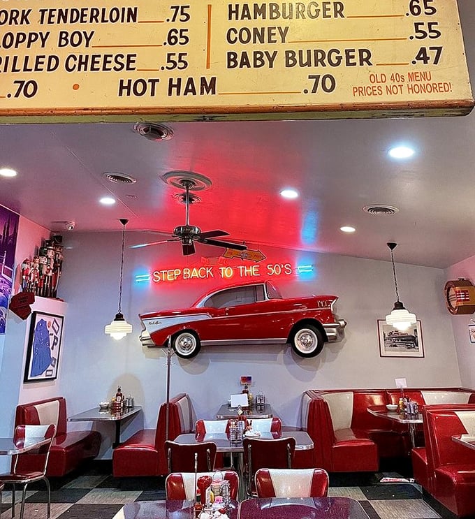 "Step Back to the 50's" isn't just a neon sign – it's a promise delivered through red booths, classic car decor, and food that predates food photography.