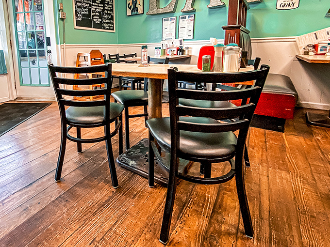 Simple wooden floors, practical tables, and chairs that have heard a thousand stories—diner design 101 where function creates its own kind of beauty.