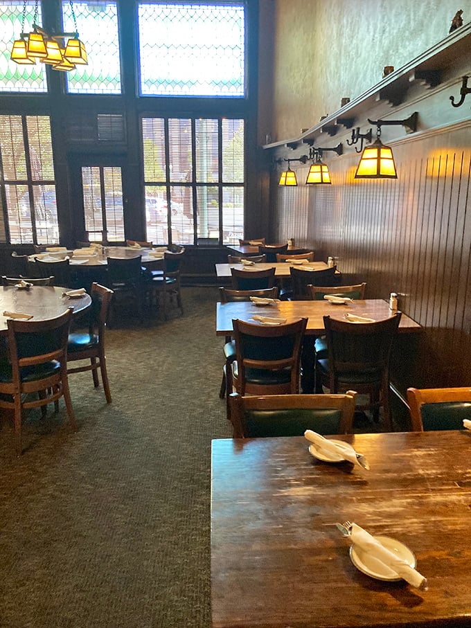 Dark wood, warm lighting, and tables set with care—this dining room doesn't just serve meals, it serves memories that linger long after the plates are cleared. 