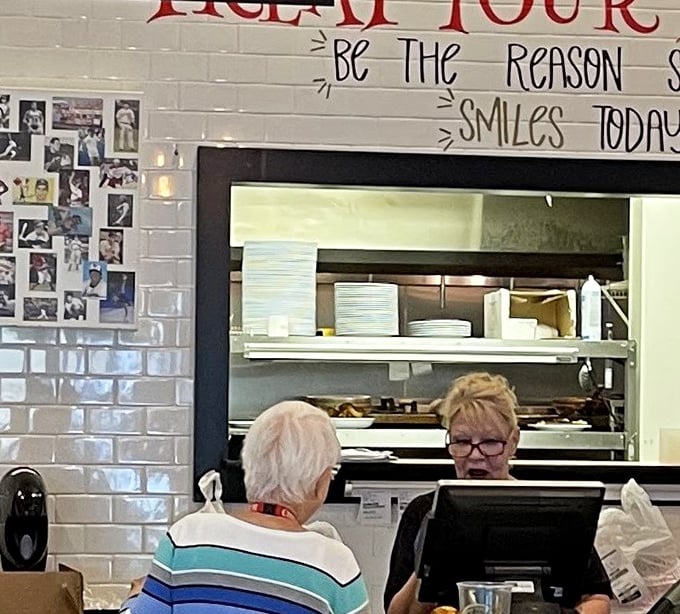 "Be the reason someone smiles today"—sage advice hanging above a counter where sandwich artists craft edible masterpieces that guarantee those smiles.