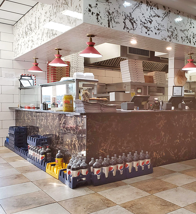 The heart of operations – where orders transform from scribbled notes to plates of happiness under blue pendant lights. 