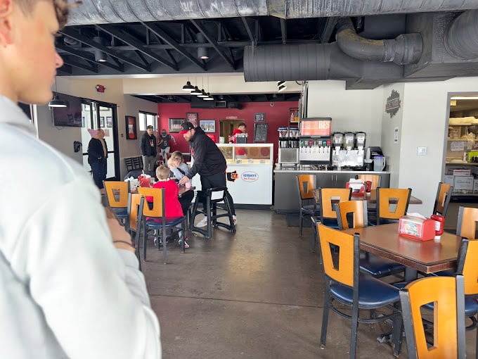 Where BBQ magic happens daily. That red accent wall has witnessed countless "first bite" faces—the kind that turn strangers into regulars.