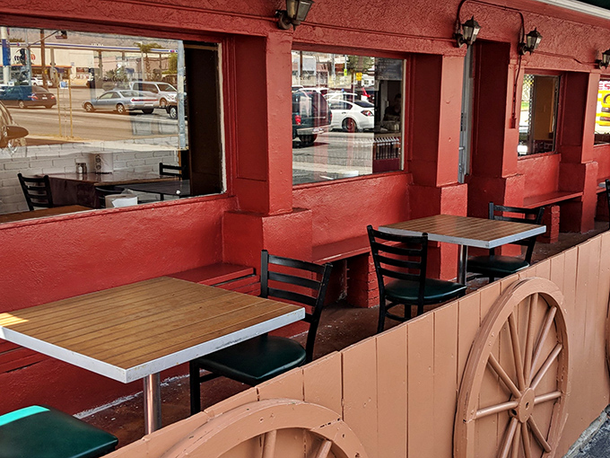 The outdoor seating area feels like a friend's backyard—casual wooden tables where BBQ memories are made between bites.