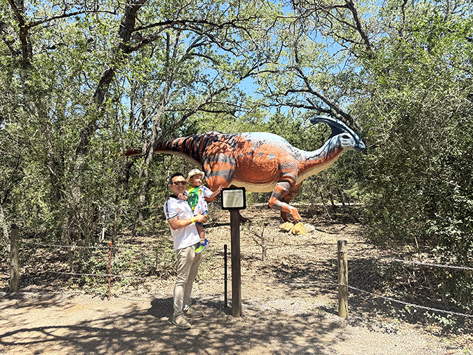 Family bonding reaches across 65 million years as parents and children share moments of wonder beneath ancient shadows.