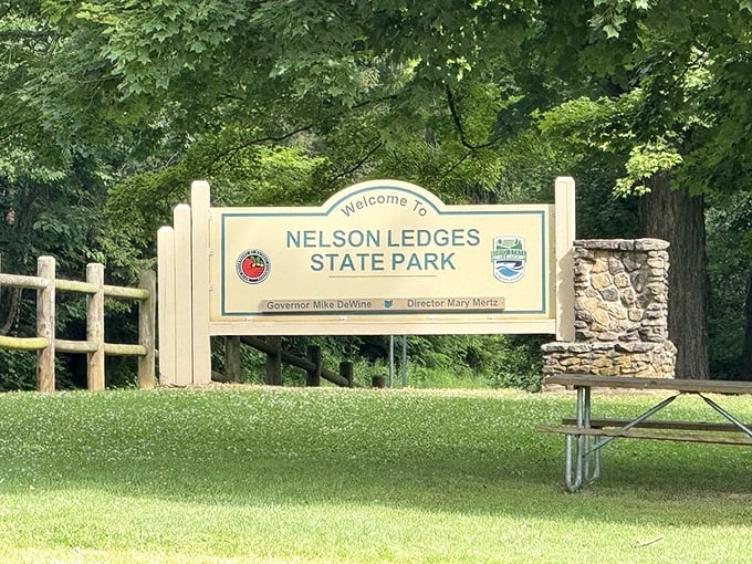 Welcome to Nelson Ledges State Park – six words that promise adventure, though the stone pillar seems to add "and yes, we're fancier than you expected."