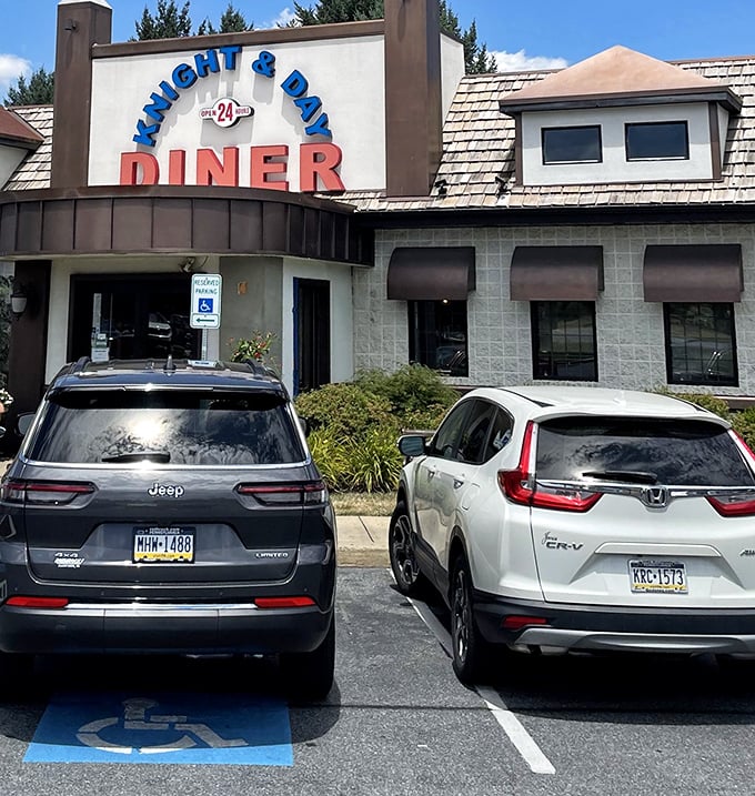 Even the parking lot tells a story—Knight & Day welcomes all, from Jeeps to Hondas. The "24" in the sign promises round-the-clock comfort.