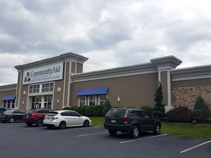The exterior might be modest, but the parking lot tells the real story—cars from counties away come for CommunityAid's legendary selection.
