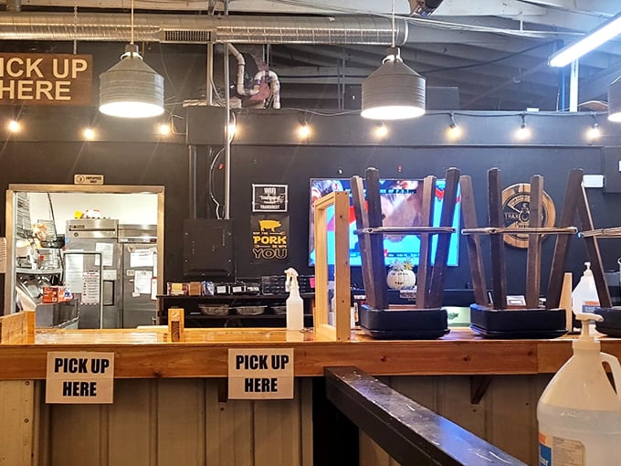 The pickup area—where dreams come true and patience is rewarded. Those drink dispensers stand like sentinels guarding liquid refreshment.