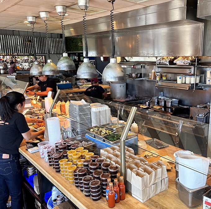 Where the magic happens—a bustling production line where smoke meets meat. Like watching a well-choreographed dance, if the dancers were handling brisket instead of ballet shoes.