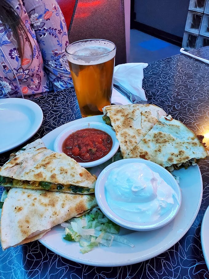Quesadillas, beer, and multiple dipping options—the holy trinity of casual dining. That melted cheese pull would make Instagram weep.