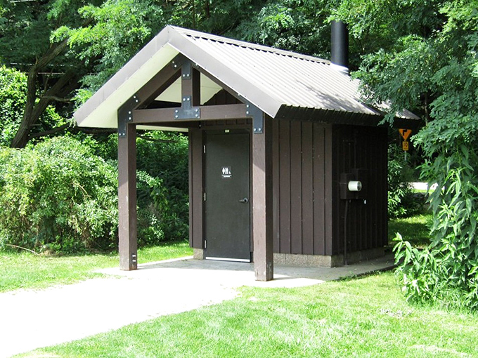 Even practical facilities get the rustic treatment here. This isn't just a restroom—it's woodland architecture with a purpose.