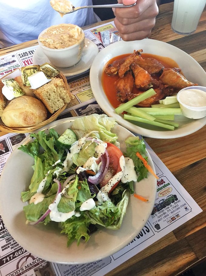 A meal that covers all bases—wings, salad, and bread. Like a baseball triple play, but for your taste buds.