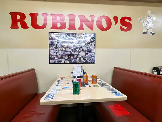 Red vinyl booths and laminate tables—the perfect stage for pizza theater. No designer furniture could possibly improve this experience.