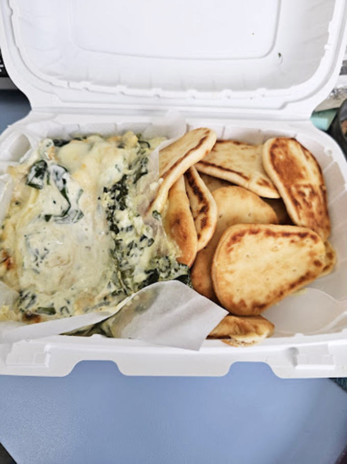 Creamy spinach dip with warm pita triangles—the appetizer that makes waiting for your main course a pleasure, not a chore.
