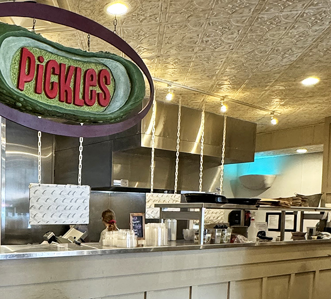 The "Pickles" sign hangs like a beacon of tangy promise. In the deli universe, a great pickle barrel is like having the ultimate supporting actor in your meal's performance.