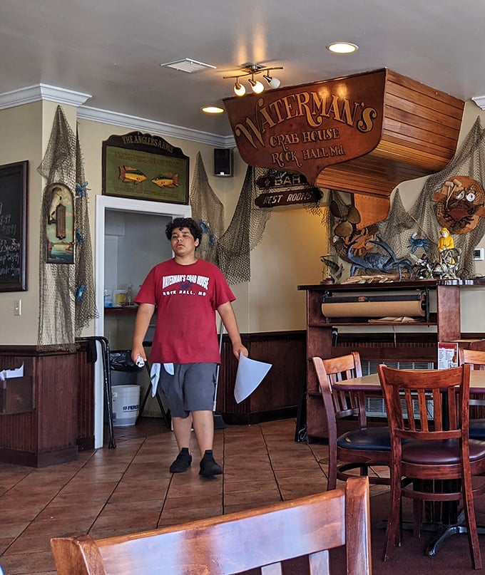 The wooden boat hanging from the ceiling isn't just decoration—it's a reminder that at Waterman's, the connection to the bay runs deeper than decor.