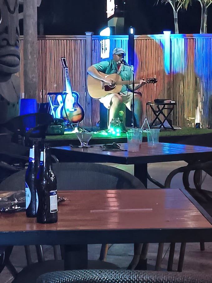 Live acoustic performances add authentic island ambiance without overwhelming the intimate conversational atmosphere throughout evenings.