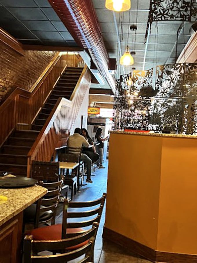 The staircase leads to more seating, but the real journey at Carmi is through generations of soul food tradition, one bite at a time.