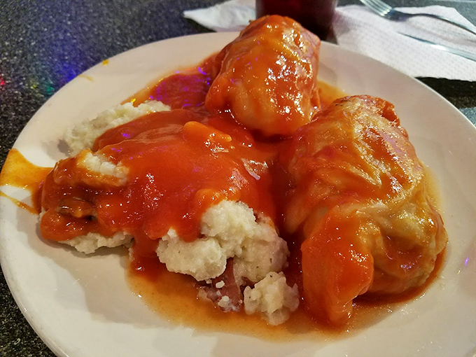 Stuffed cabbage rolls swimming in tomato sauce – the kind of dish that makes you understand why comfort food earned its name.
