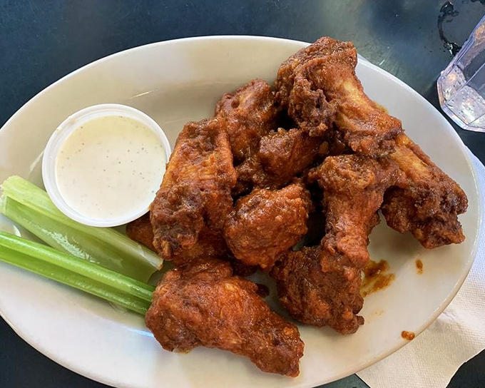 These wings aren't just crispy, they're having an identity crisis about whether they're potato chips—served with cooling celery and creamy dipping sauce.