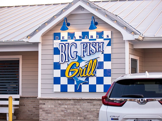 Big Fish Grill's cheerful exterior stands out like a sunny day, promising seafood treasures inside this beloved Rehoboth institution.