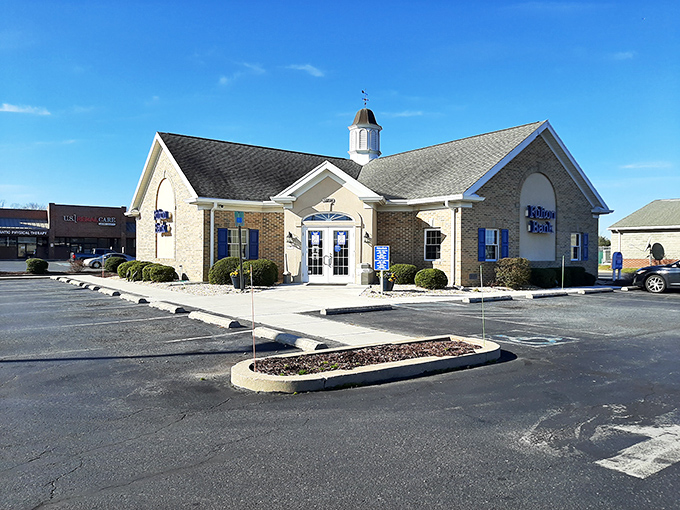 This charming building with its bright blue shutters and cupola houses a local business in Laurel. The neat landscaping welcomes visitors with small-town hospitality.