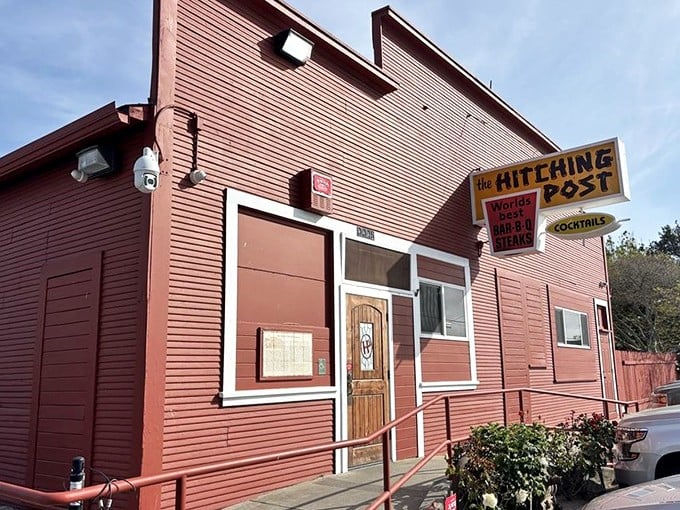 The Hitching Post's rustic red exterior has been welcoming hungry travelers for generations. Like stepping into a BBQ time machine where the recipes never needed updating.