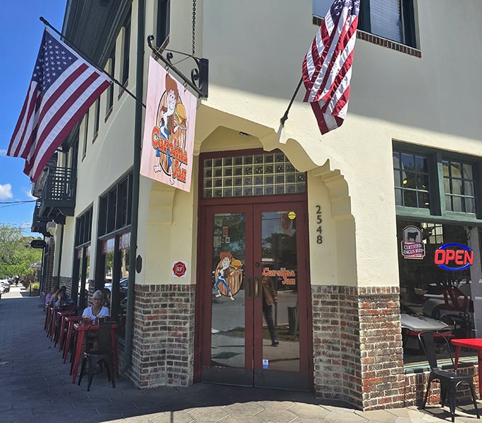 The entrance to Carolina Jax showcases its architectural character. American flags and burger excellence—what could be better?
