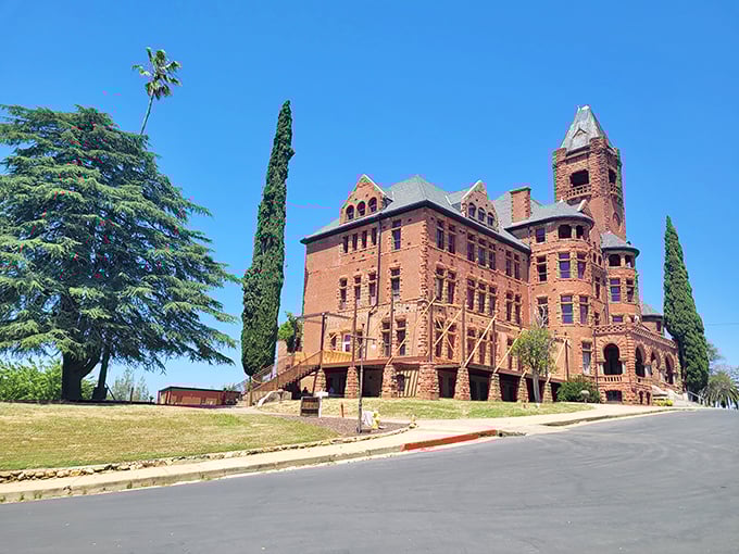 Preston Castle: Massive brick walls and Gothic windows stand proudly against the blue sky—a red sandstone giant with stories to tell.