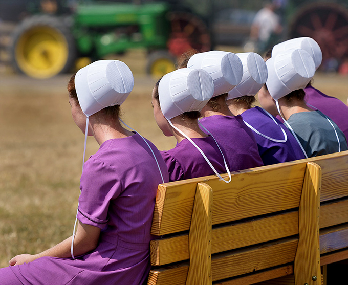 Purple dresses and white prayer caps create a visual rhythm – these young women represent a culture where community still trumps individuality.