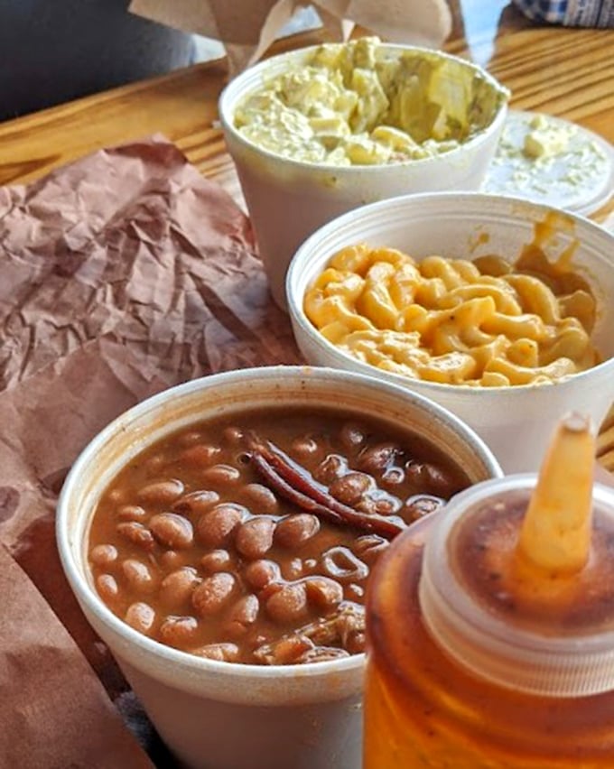 The side dish trifecta—beans, mac and cheese, and potato salad form the supporting chorus that makes the meat's solo performance even more spectacular.